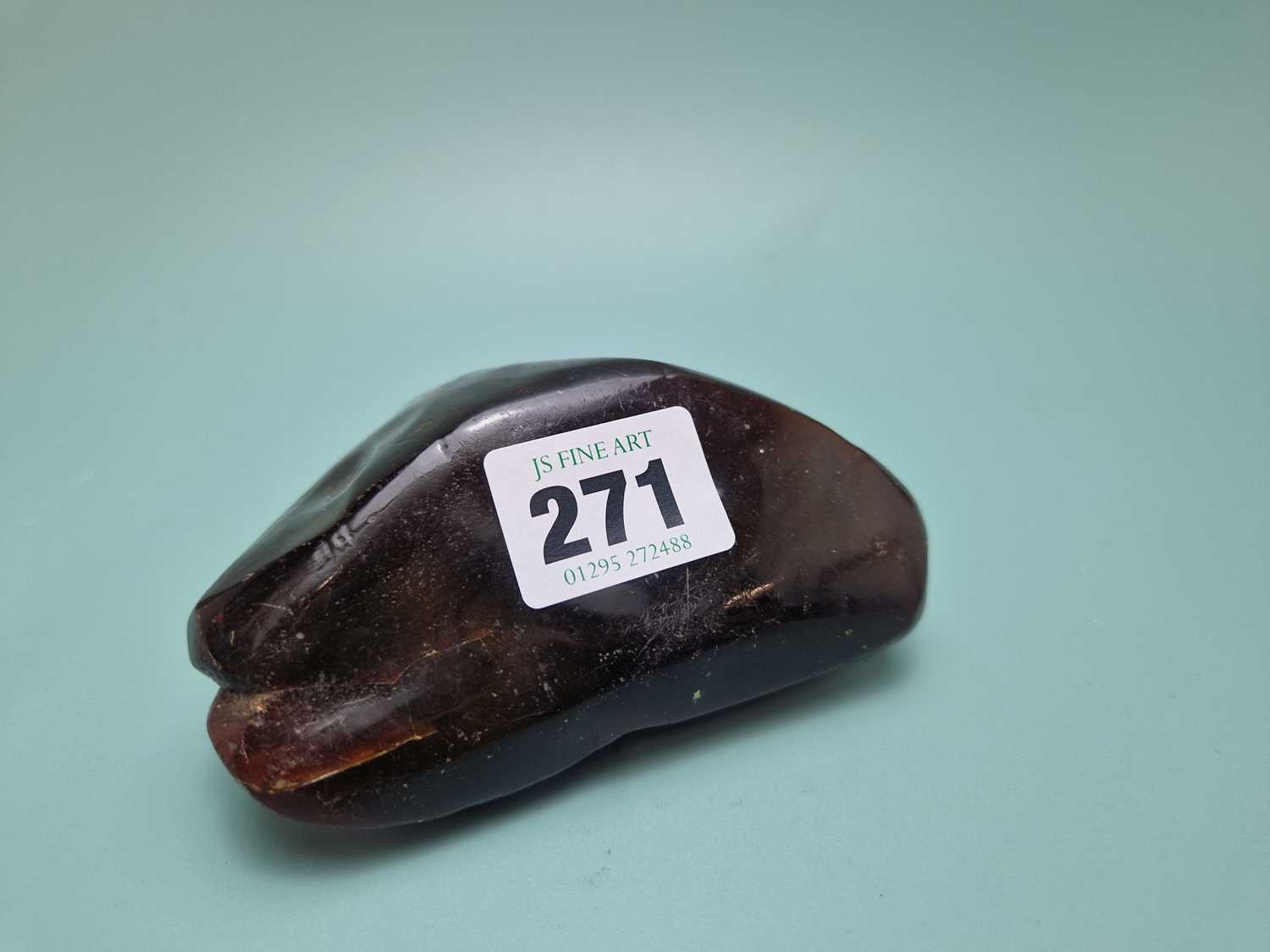 Lot 271 - A triangular pebble of amber. W 11cms.