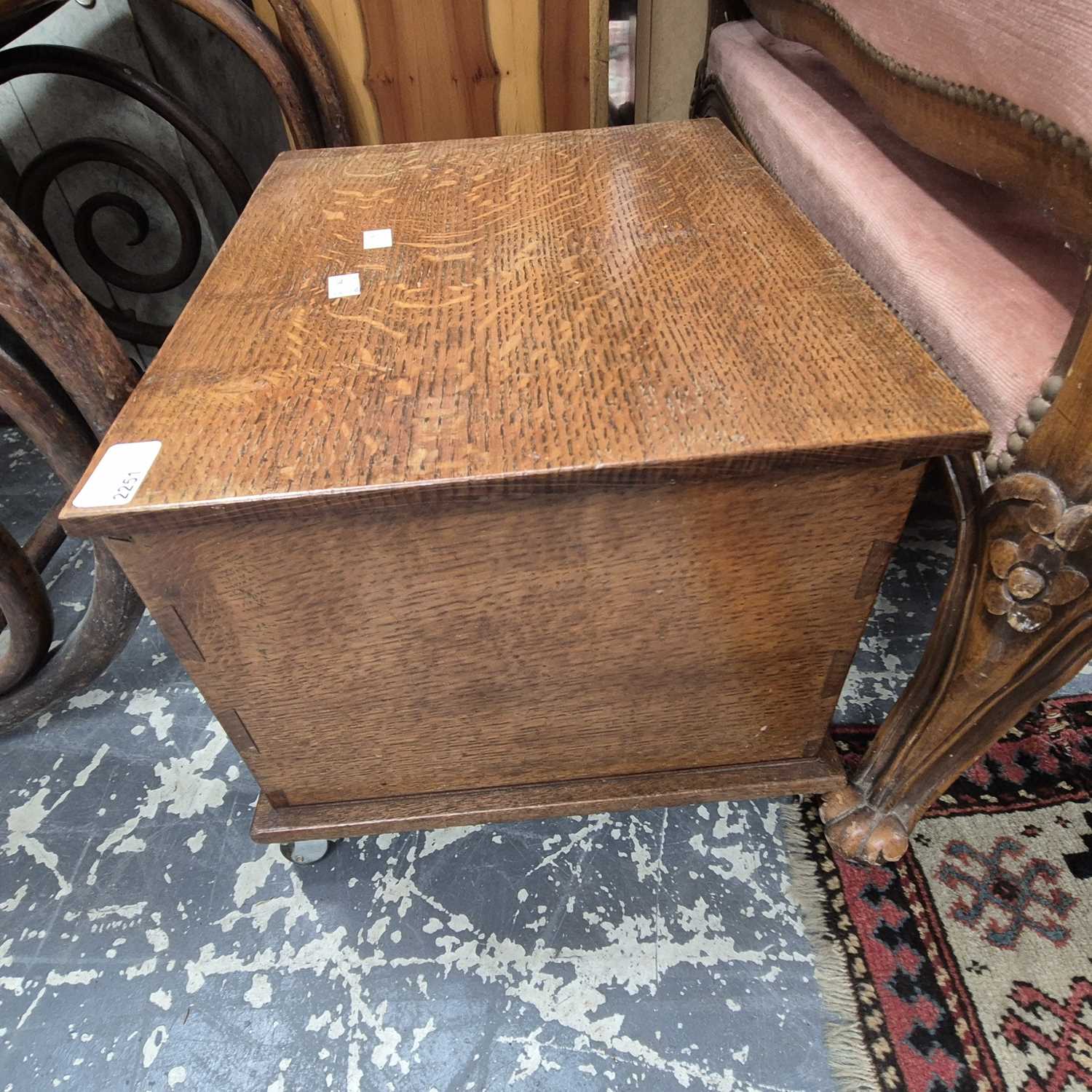 Lot 2251 - A small polished oak slipper box.