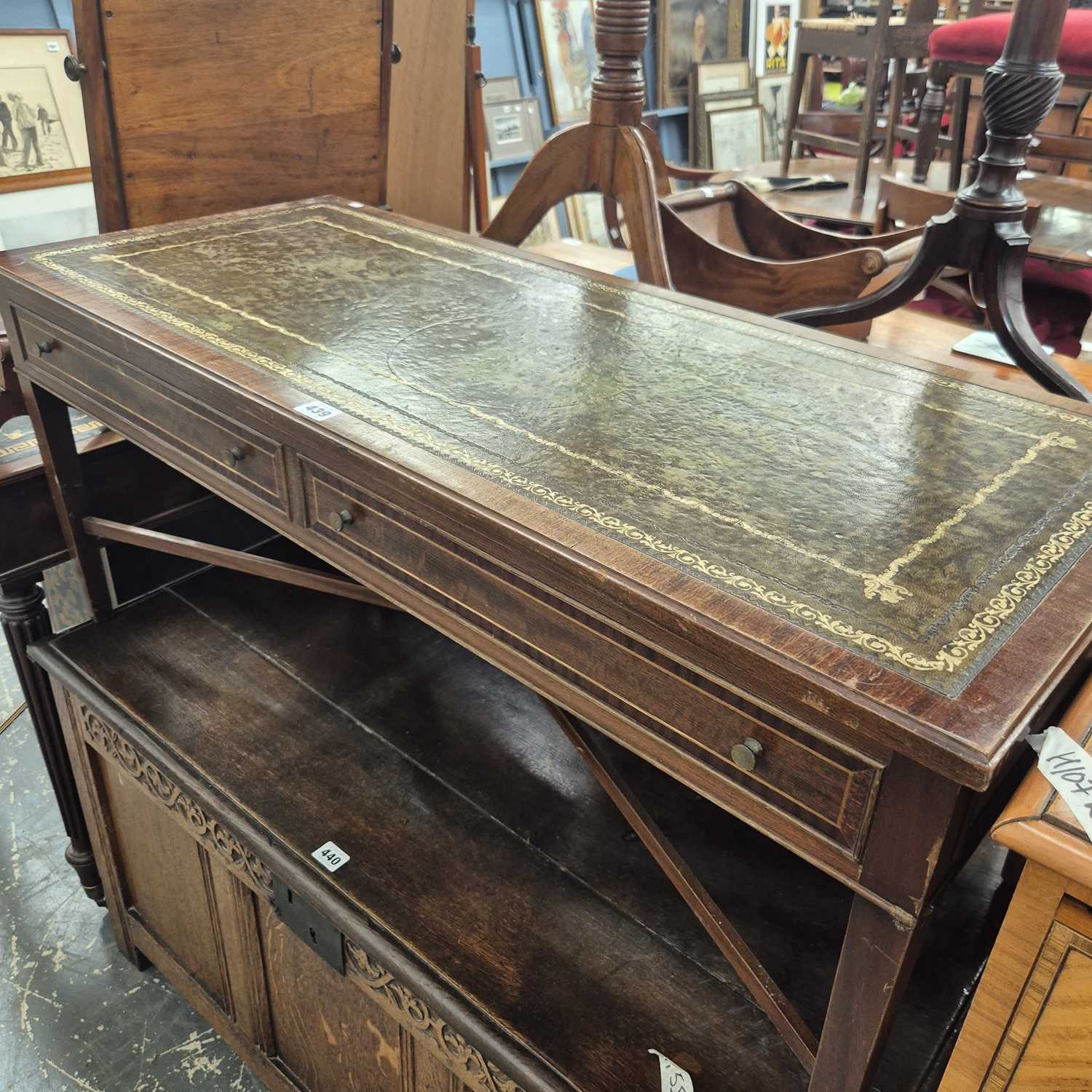 Lot 439 - A leather inset coffee table.