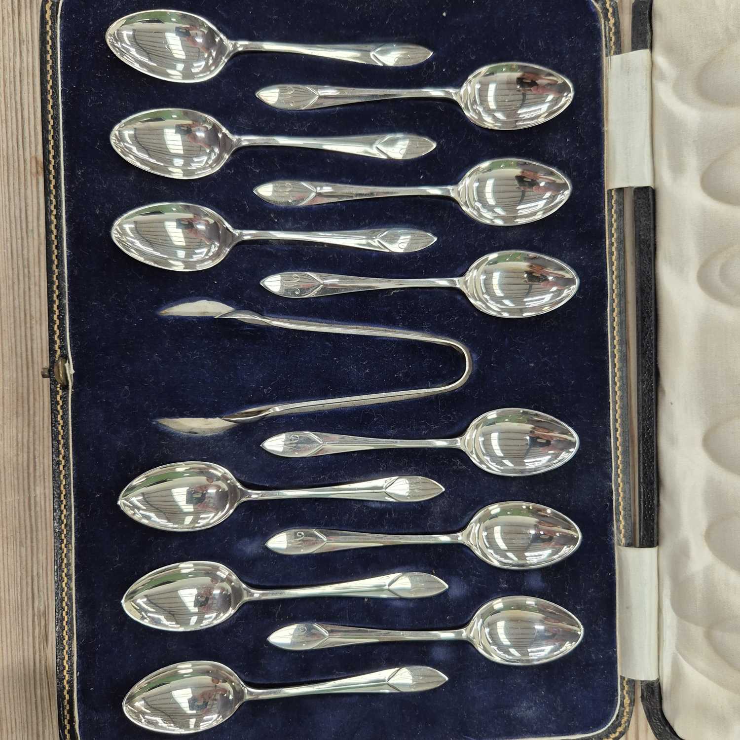 Lot 1688 - A cased set of twelve silver tea spoons