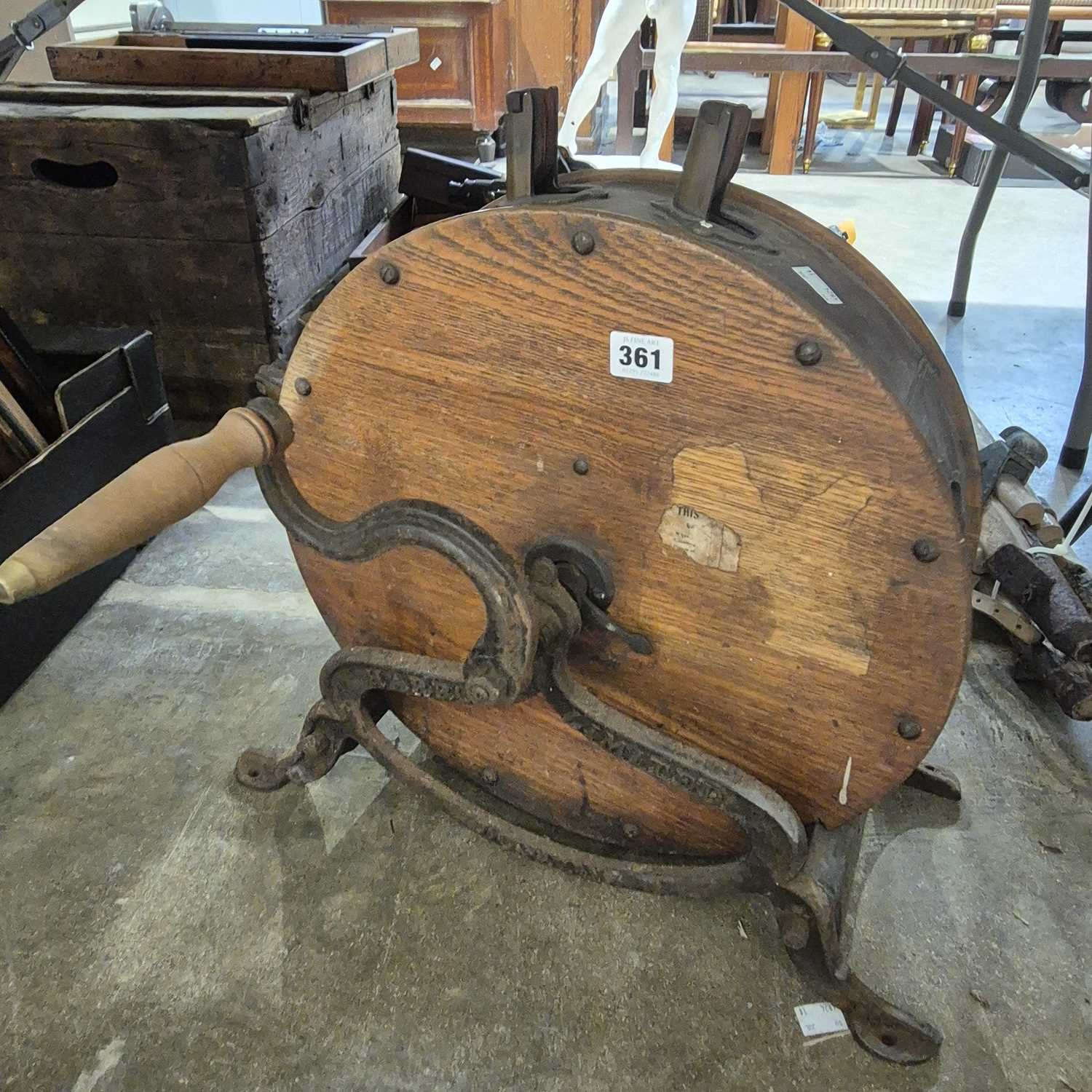 Lot 361 - A vintage cast iron and wood knife polisher