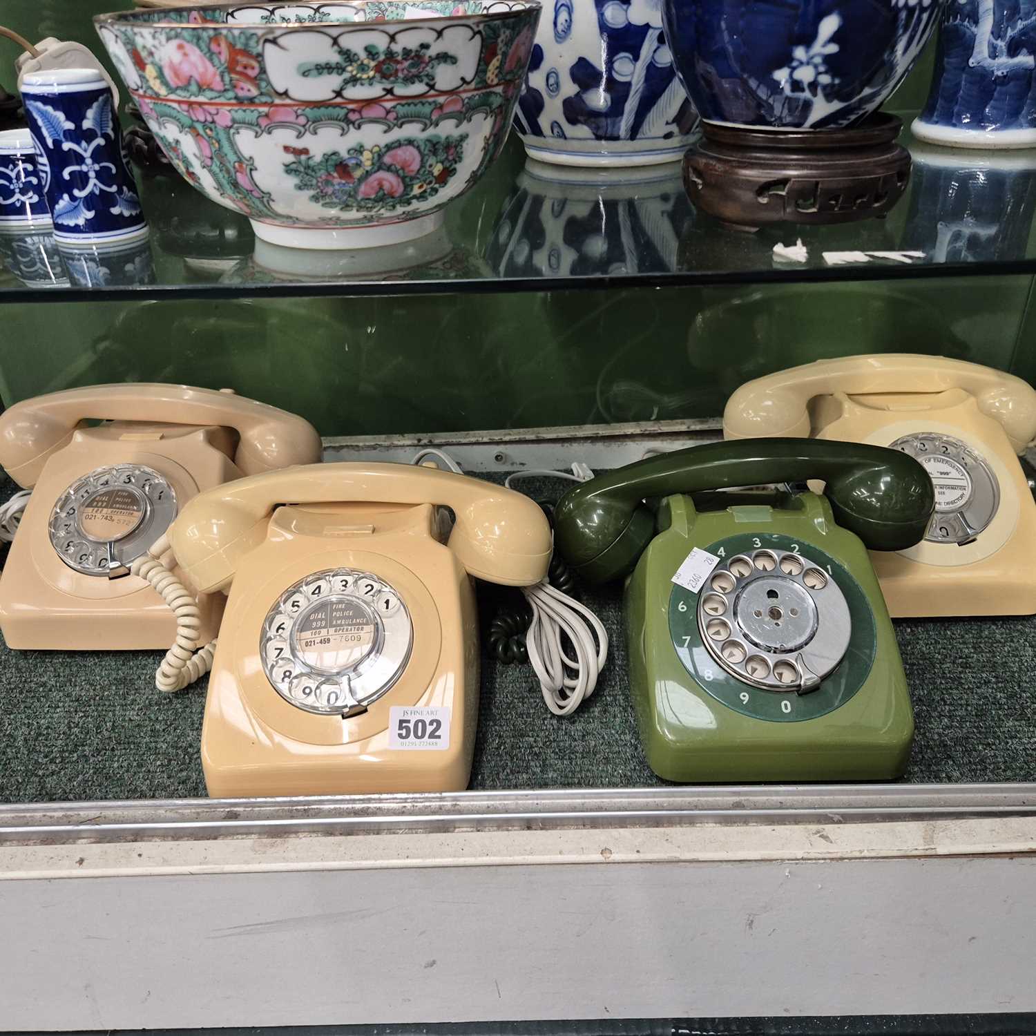 Lot 502 - A green and three cream telephone sets