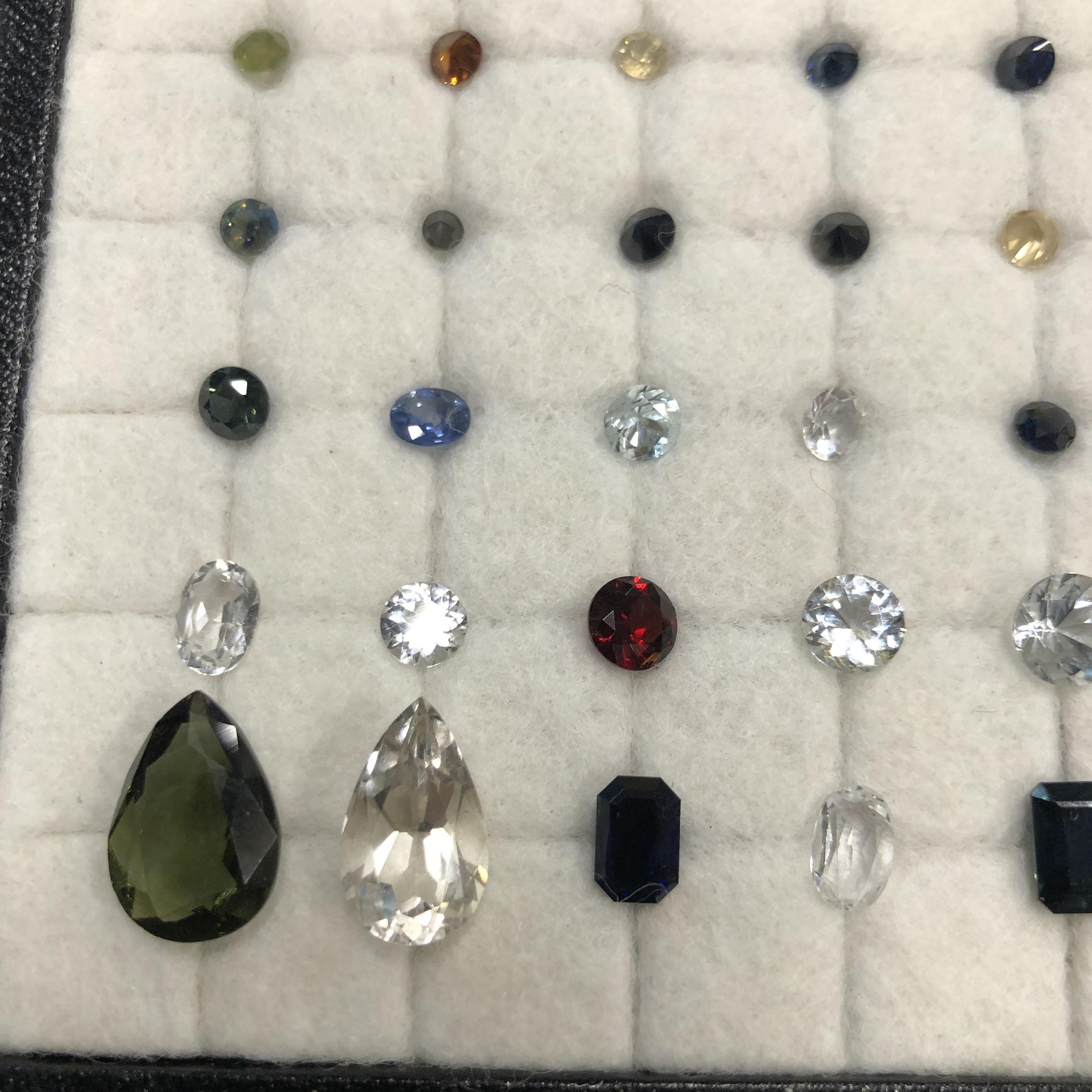 Lot 1114 - A collection of various cut gemstones,