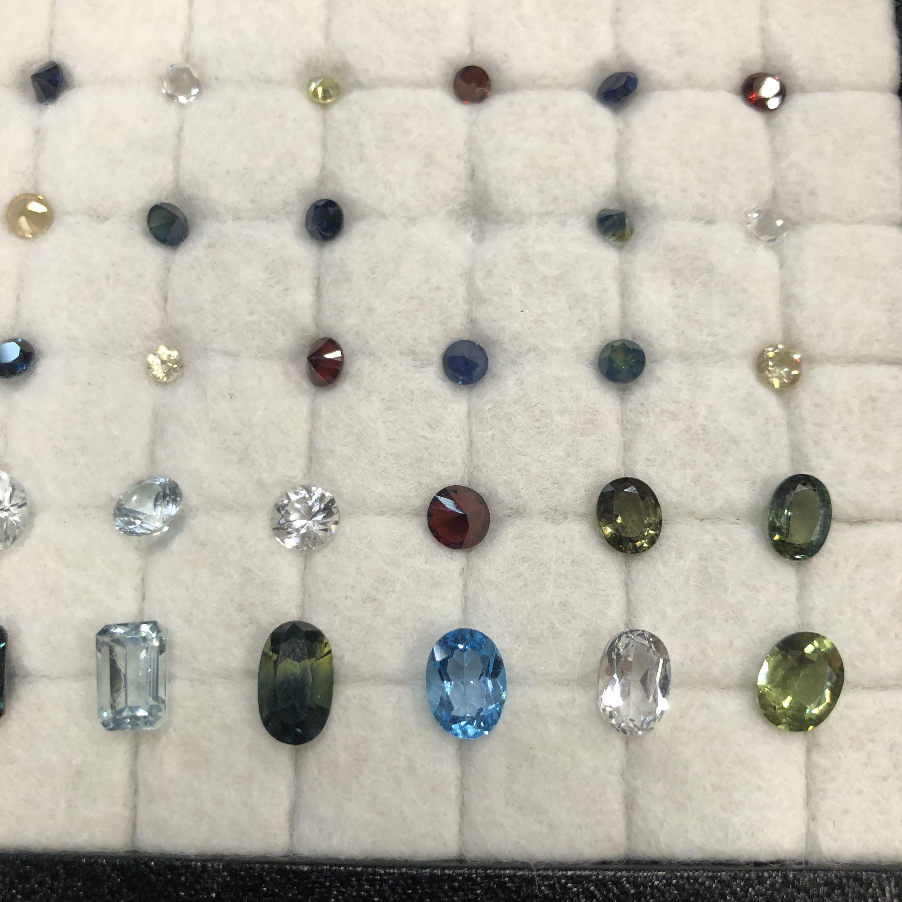 Lot 1114 - A collection of various cut gemstones,